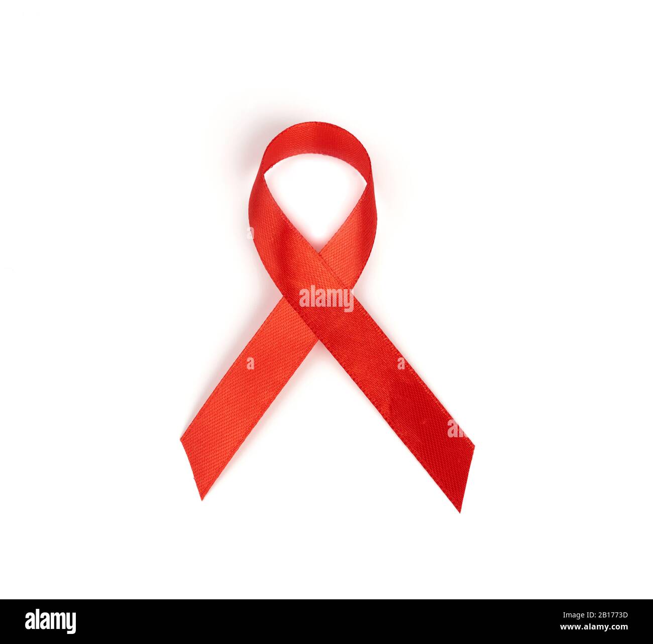 red silk ribbon twisted into a loop. Symbol of AIDS or HIV awareness ...