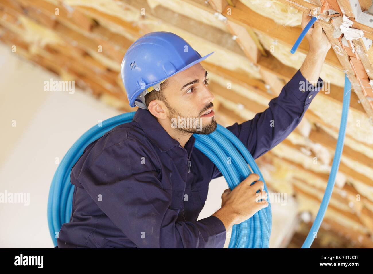 portrait of electrician fitting cables at site Stock Photo - Alamy