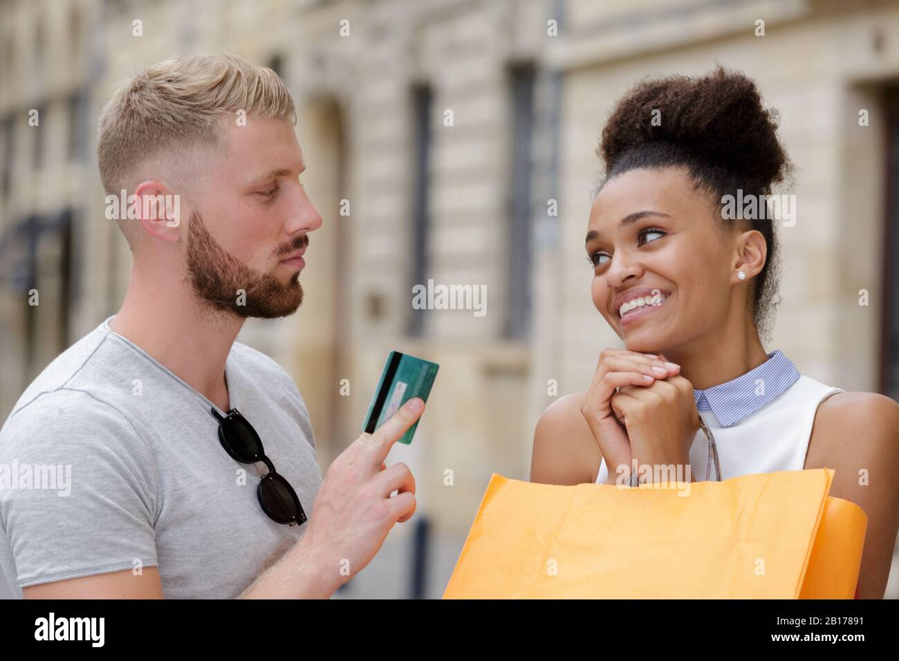 man giving his credit card to woman Stock Photo - Alamy