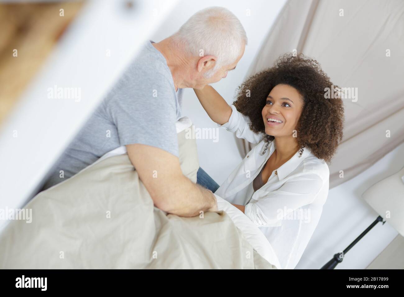 kind nurse with elderly man Stock Photo - Alamy