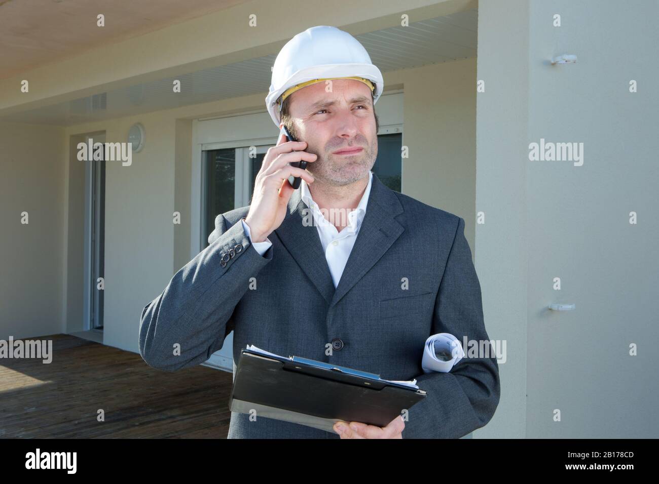site manager using cell phone Stock Photo - Alamy