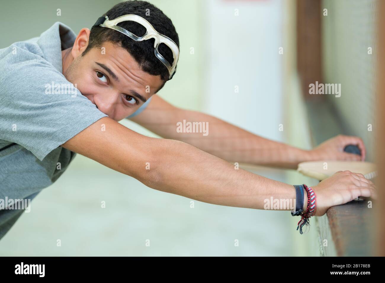 man leaning against a wall after a sports defeat Stock Photo - Alamy