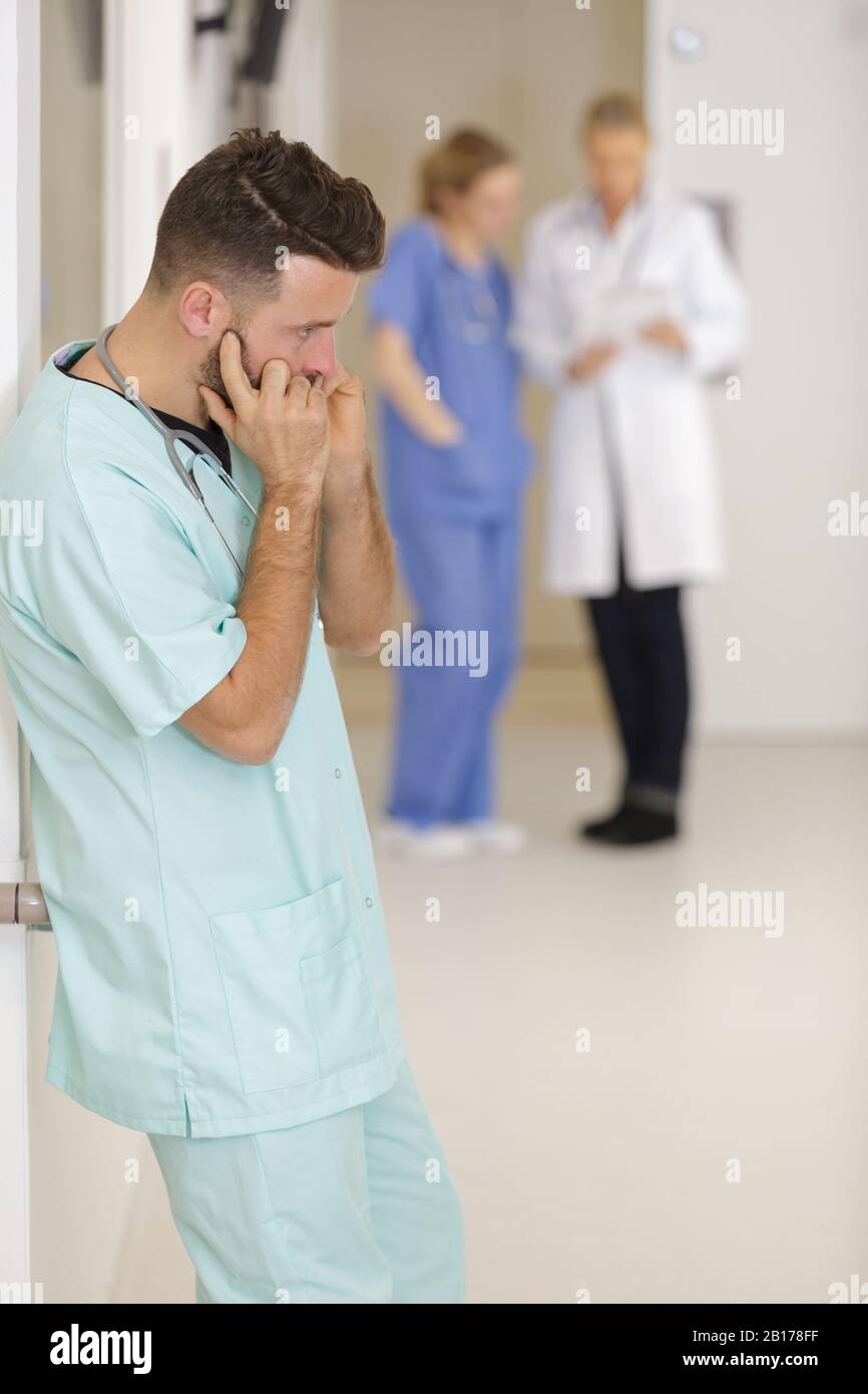 doctor taking a telephone call in hospital corridor Stock Photo - Alamy
