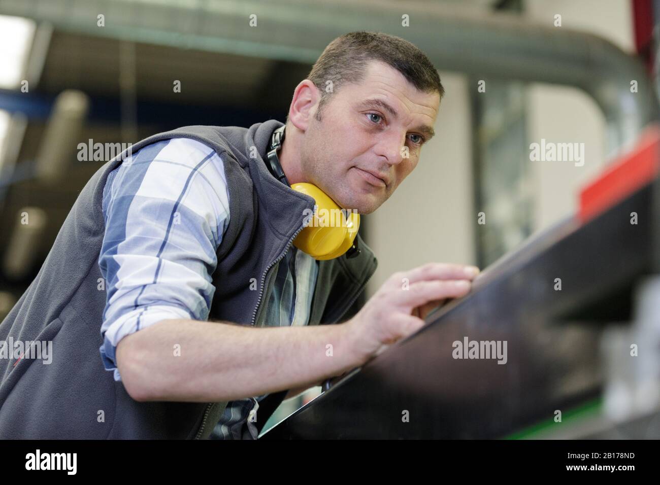 factory man worker holding metal sheet in workshop Stock Photo - Alamy