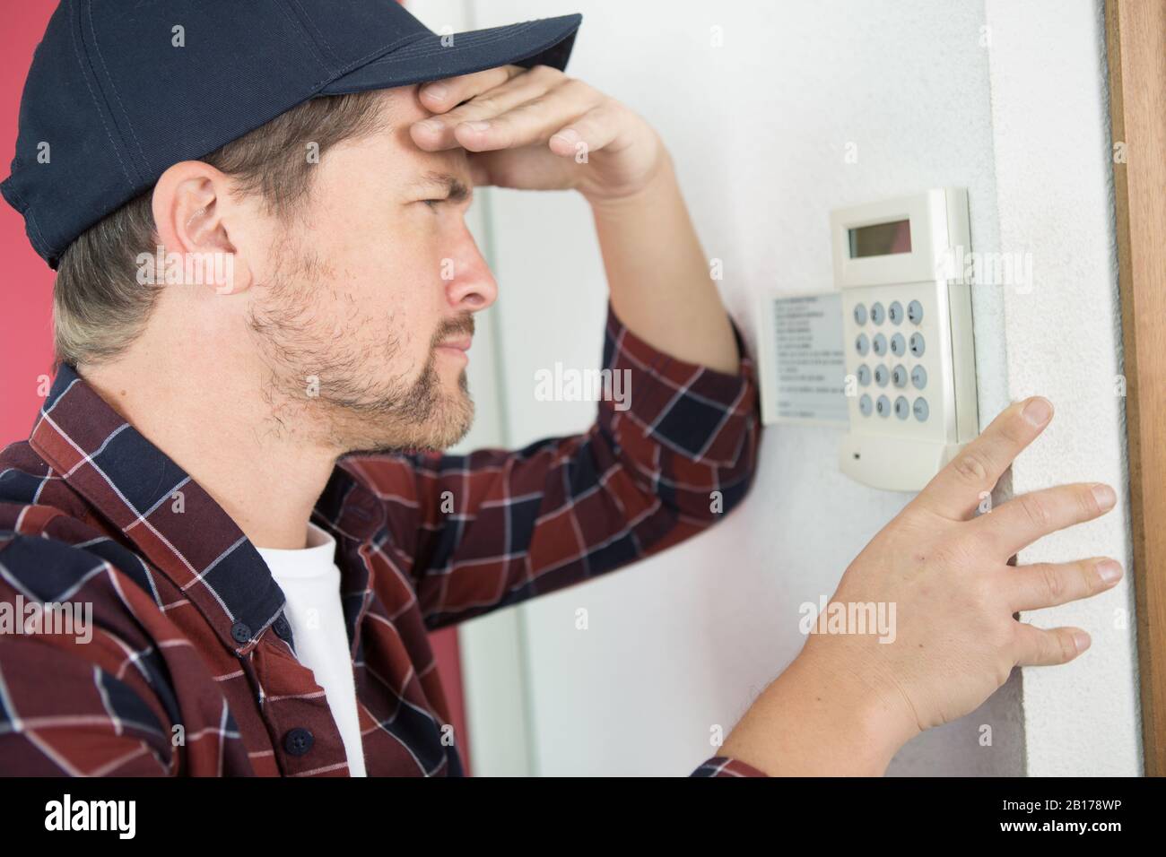 contractor with confused expression using electronic keypad Stock Photo ...