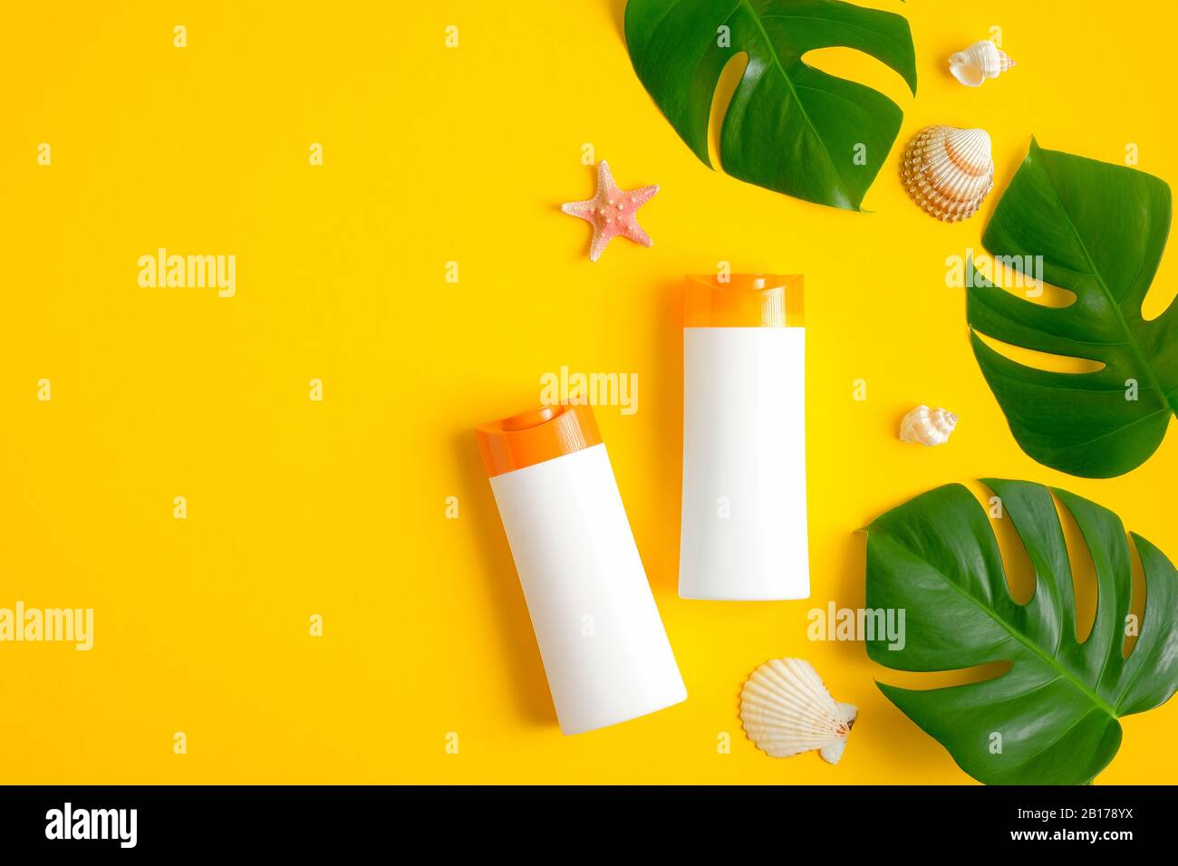 Blank sunscreen bottles mockup without labels, tropical leaves and ...