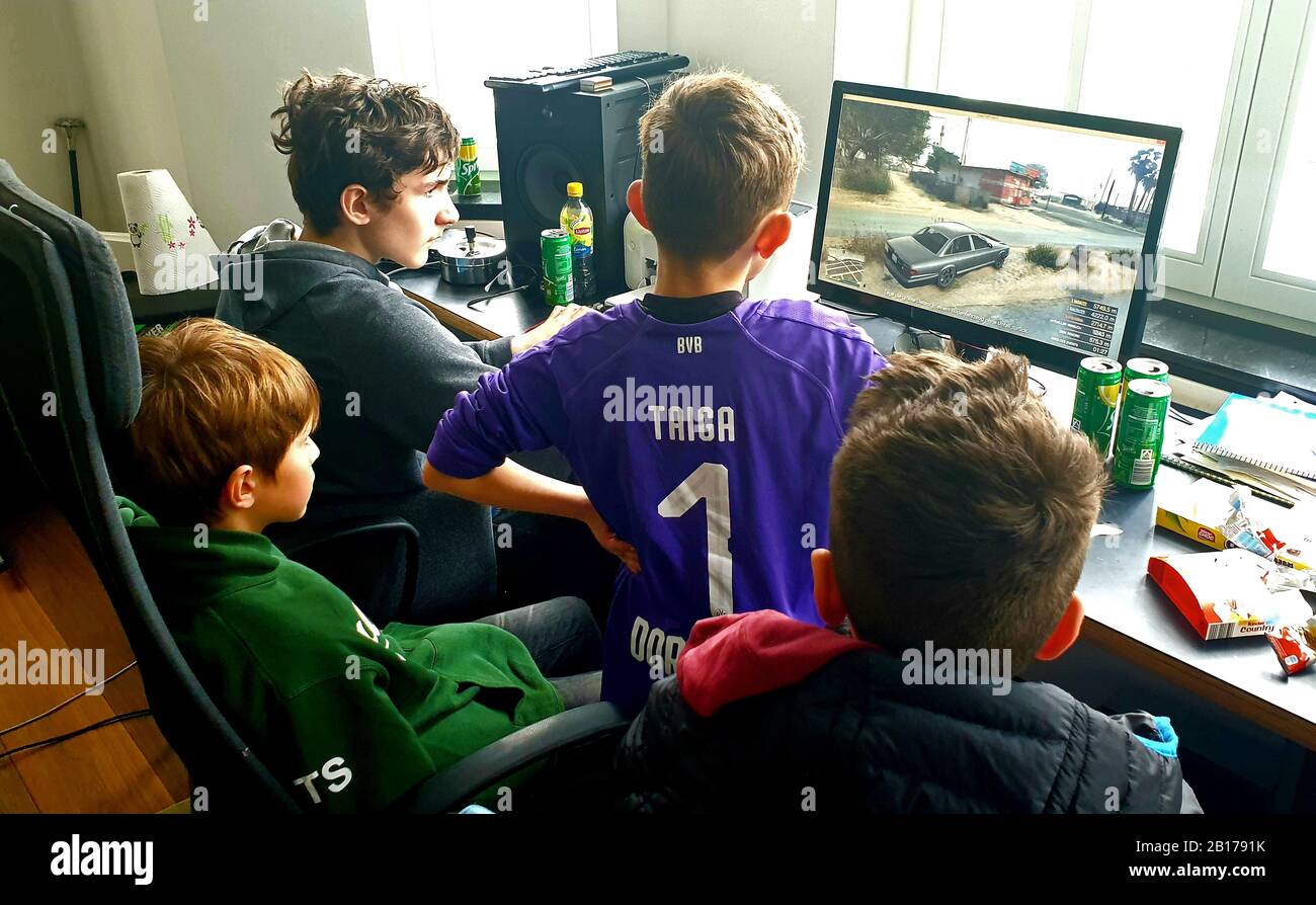 four friend playing a computer game, Germany Stock Photo - Alamy