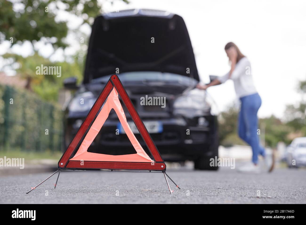 problems car and red triangle on the road Stock Photo - Alamy