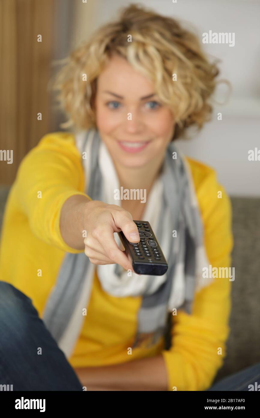Woman holds white remote hi-res stock photography and images - Alamy