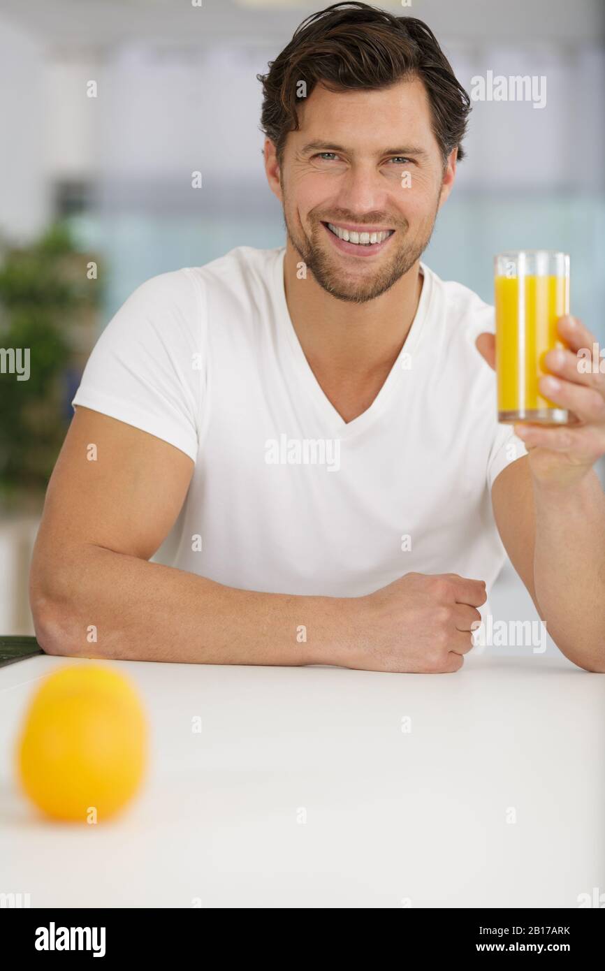 Holding glass milk orange juice hi-res stock photography and images - Alamy