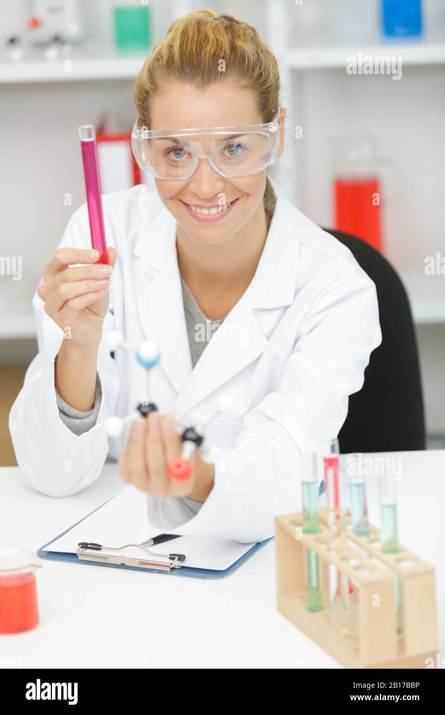 happy female worker test tube Stock Photo - Alamy
