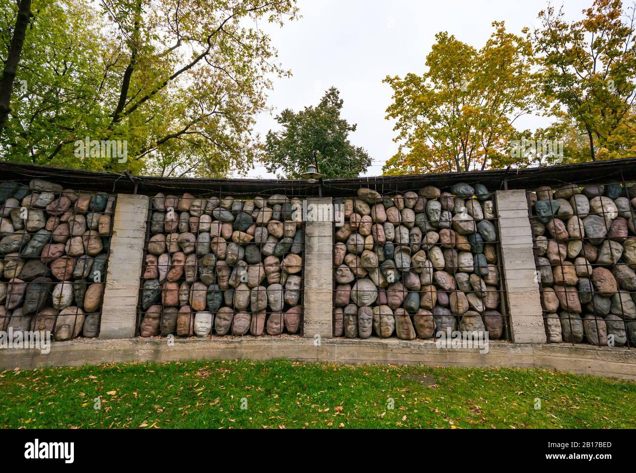 Political memorial of caged stone heads commemorating victims of ...