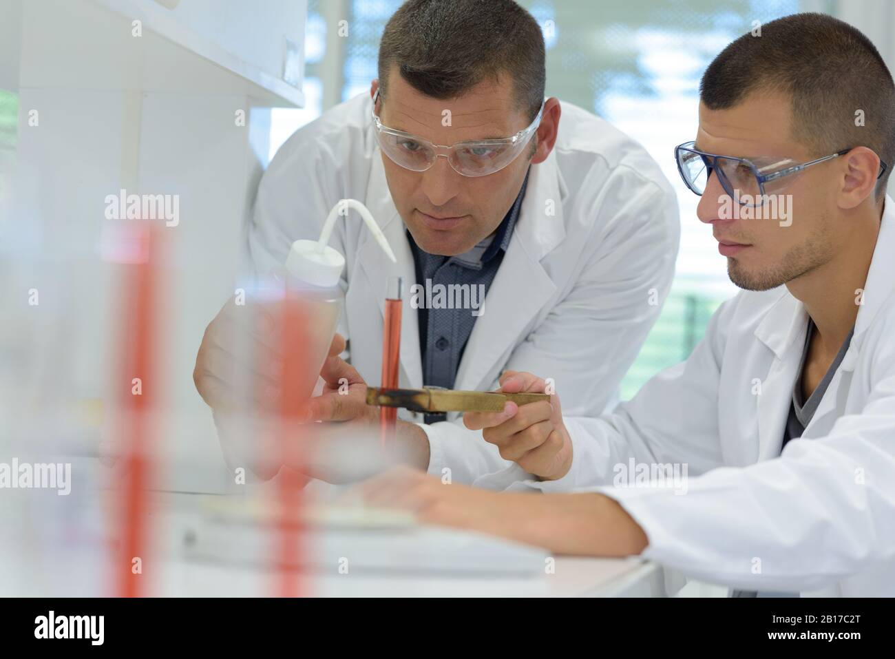 two men doing laboratory expirement Stock Photo - Alamy