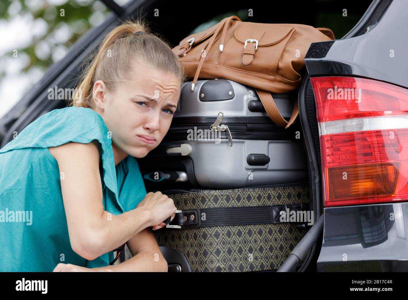 Girl loading luggage into car hi-res stock photography and images - Alamy