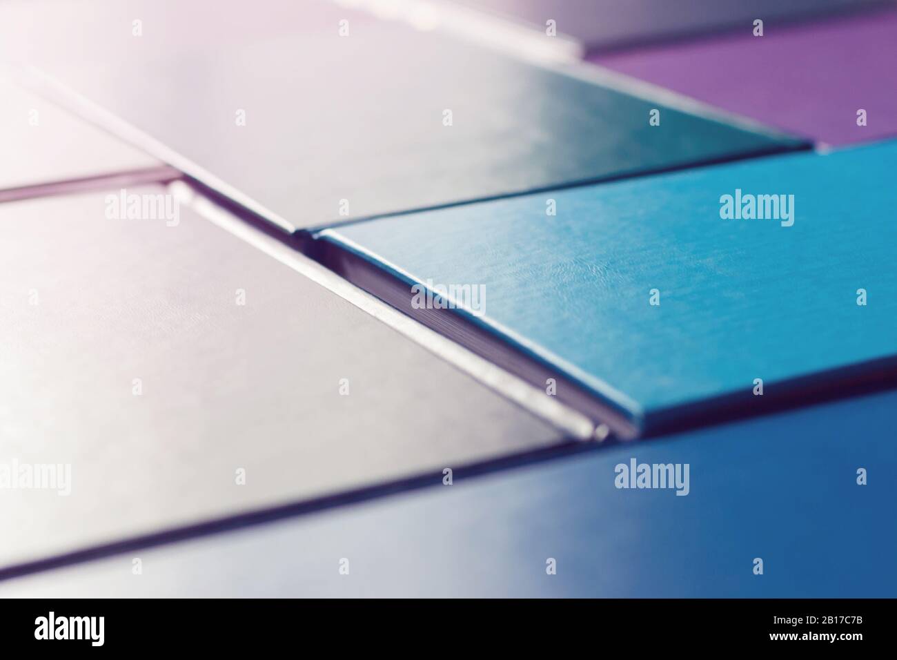 Background of books with blue and purple book covers Stock Photo - Alamy