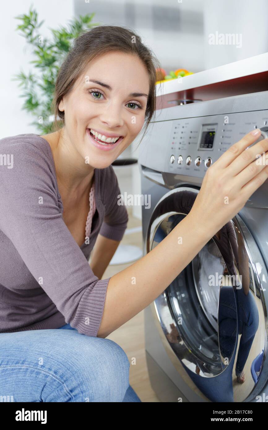 Happy woman using washing machine hi-res stock photography and images ...