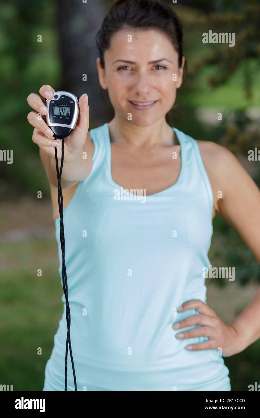 Female holding stopwatch hi-res stock photography and images - Alamy