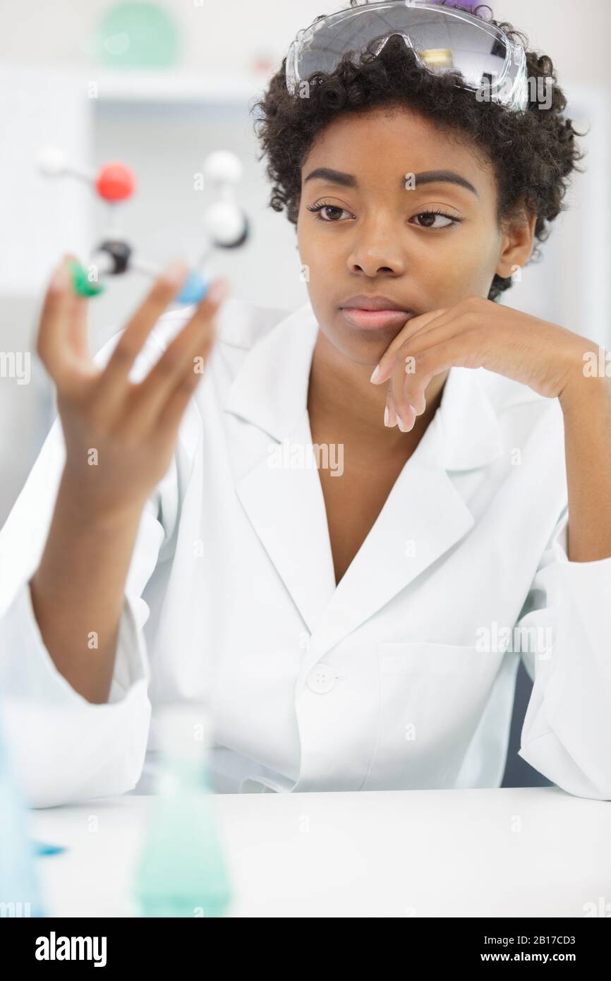 female lab worker holding a medical dna figure Stock Photo - Alamy