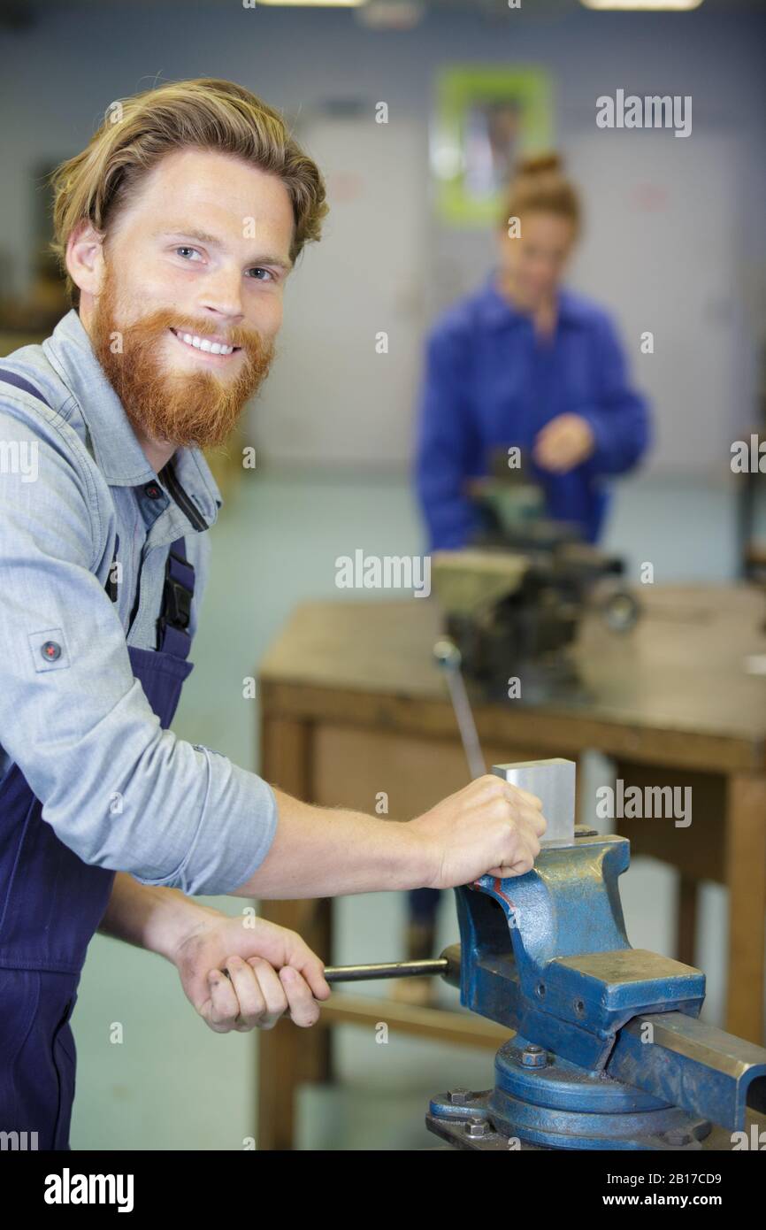 happy male worker working in workshop Stock Photo - Alamy