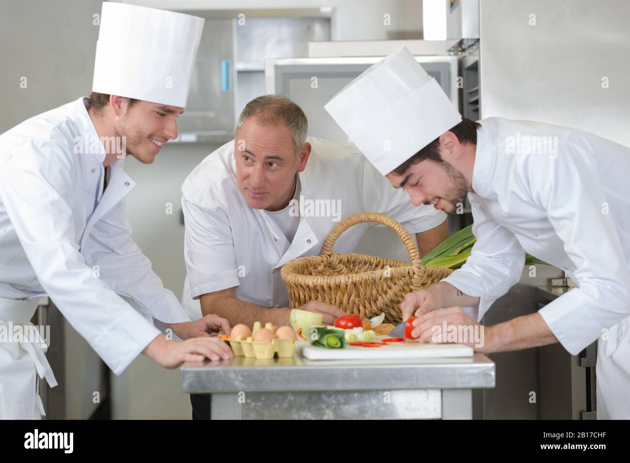 chefs preparing food in the kitchen of a restaurant Stock Photo - Alamy
