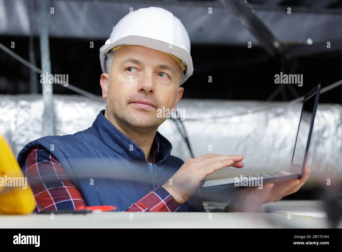 Construction worker using laptop hi-res stock photography and images ...