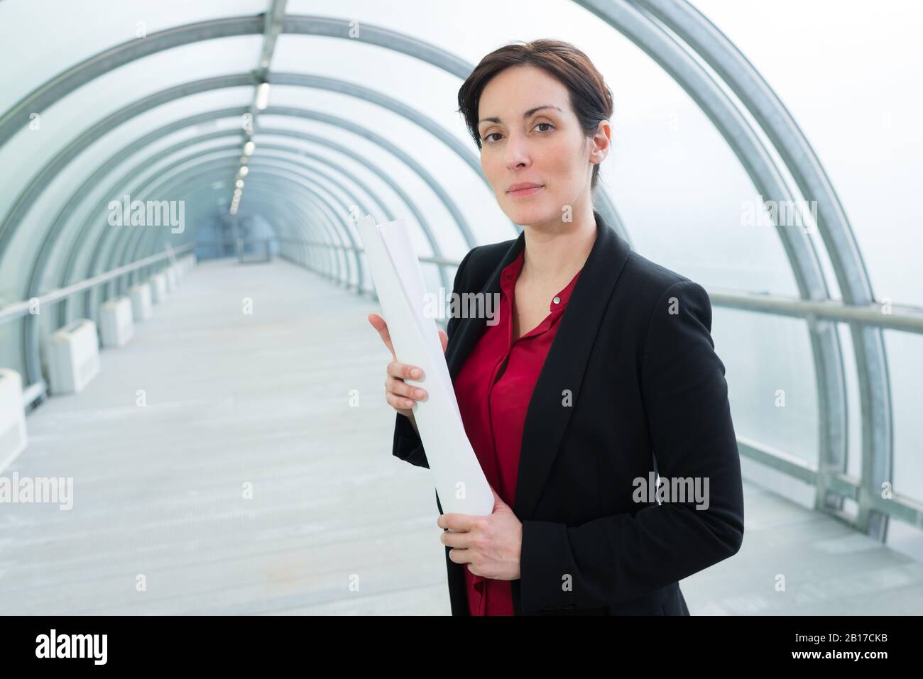 female elegant engineer holding project of work Stock Photo - Alamy