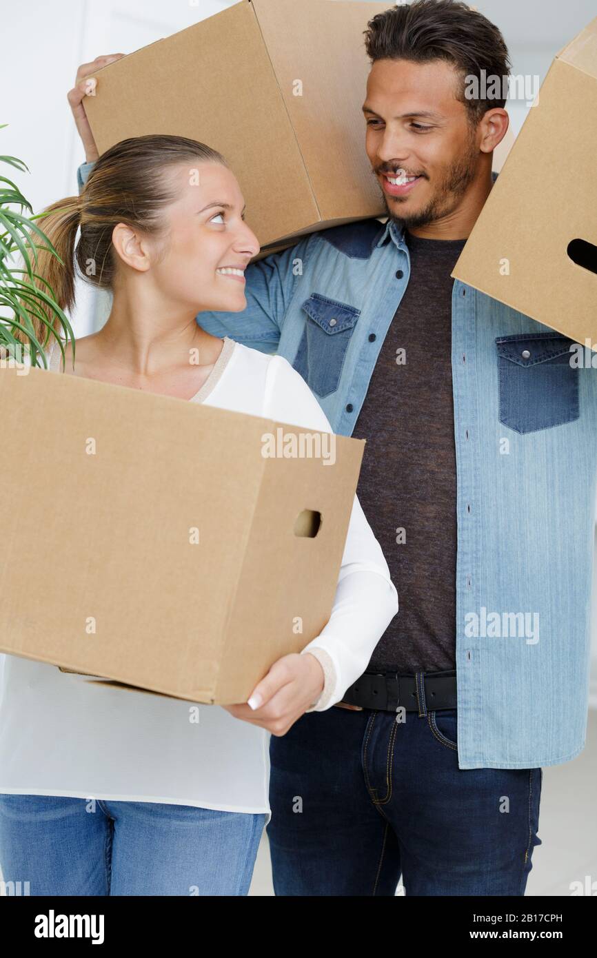 couple standing holding cardboard boxes Stock Photo - Alamy