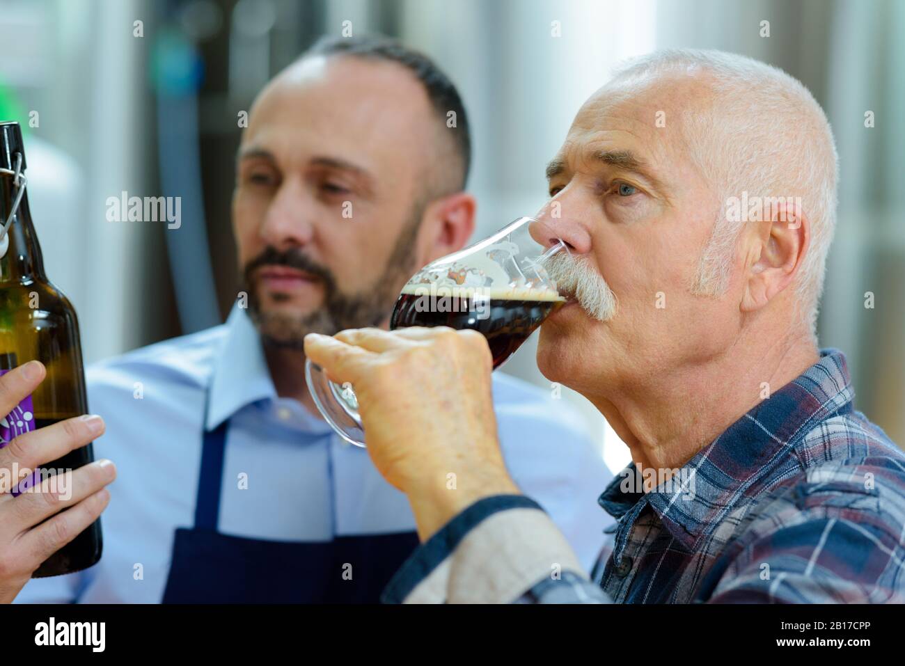 senior gentleman tasting craft beer Stock Photo - Alamy