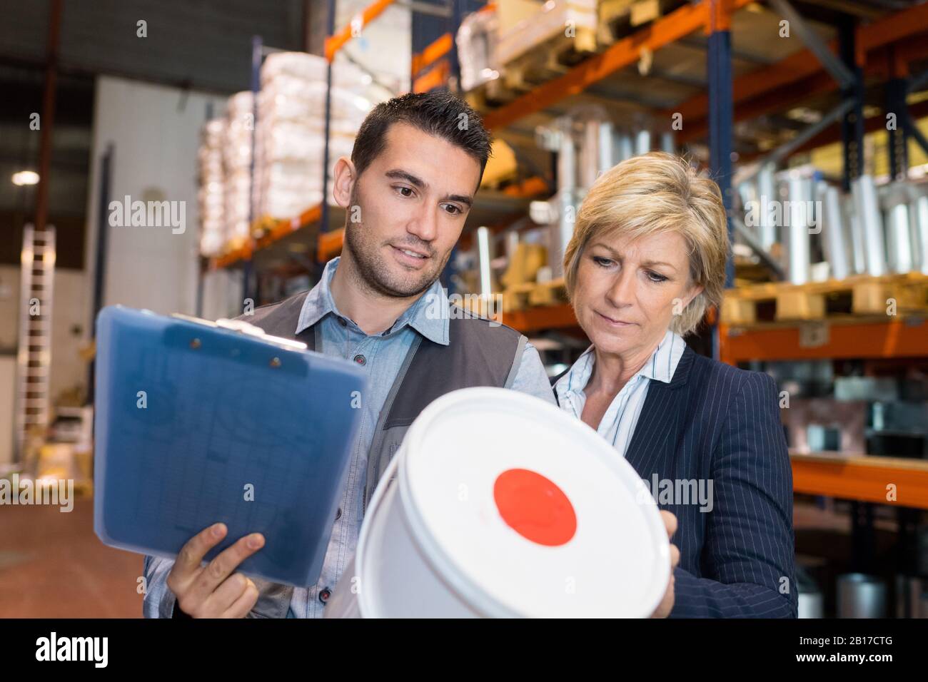 manager with worker in warehouse Stock Photo - Alamy