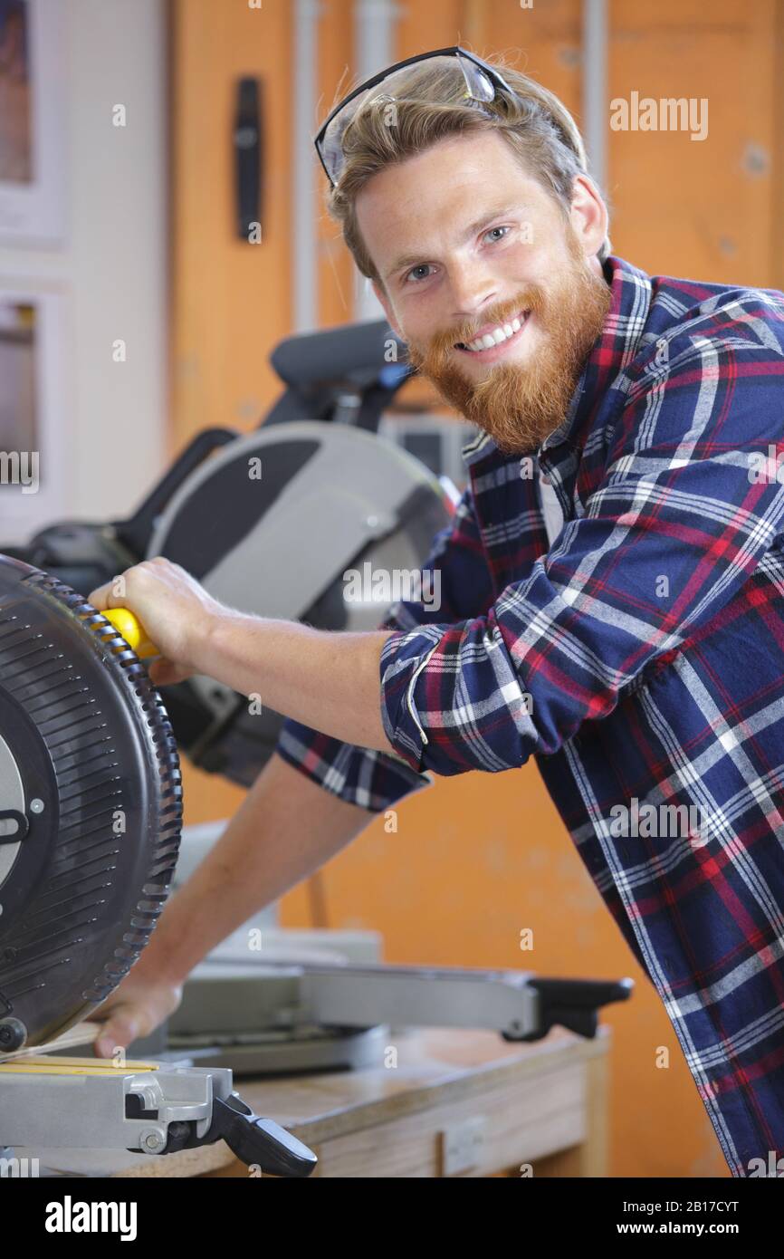 man cutting huge piece of wood by electric circular saw Stock Photo - Alamy
