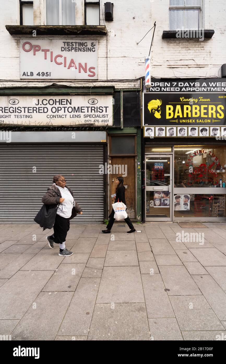 Barking Road shops - Optician and Barbers Stock Photo - Alamy
