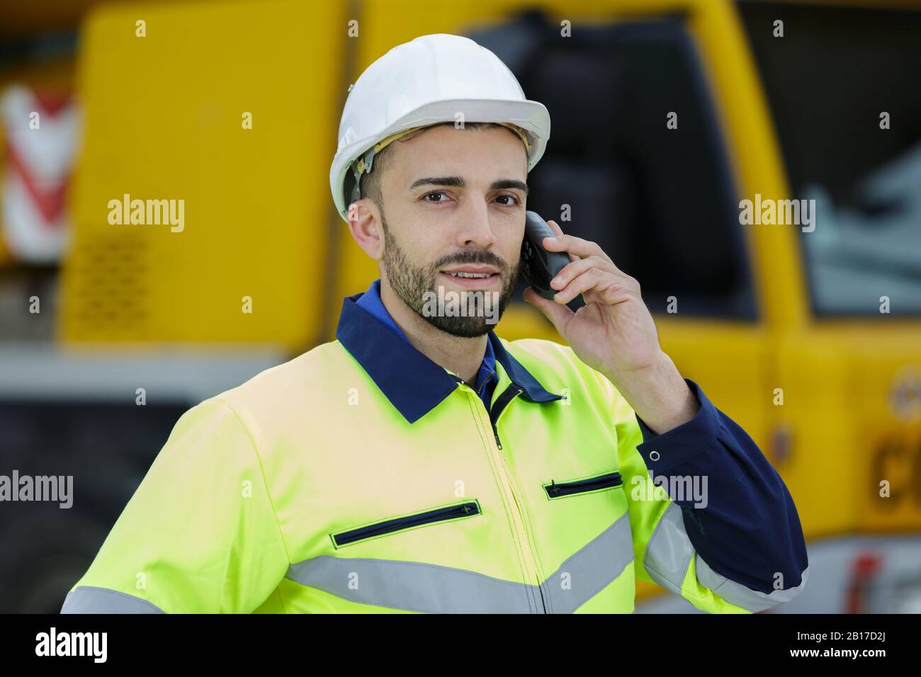 man wearing reflective jacket talking on telephone Stock Photo - Alamy