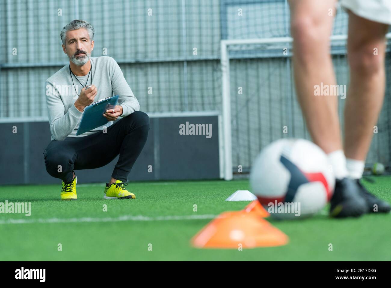 football coach watching young man training Stock Photo - Alamy