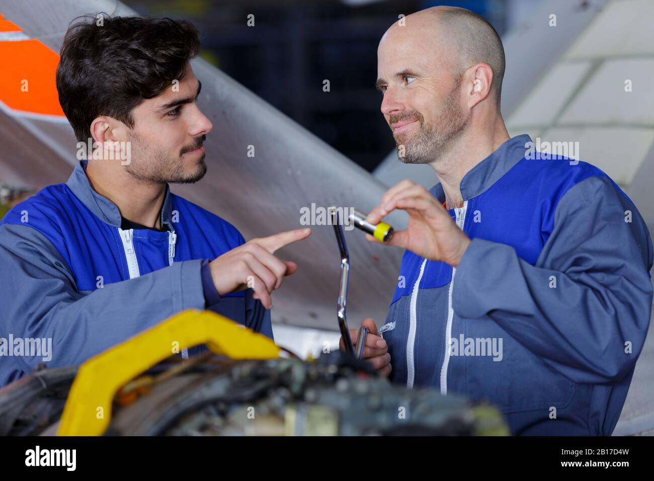 aerospace engineers using lamp to work on aircraft engine Stock Photo ...