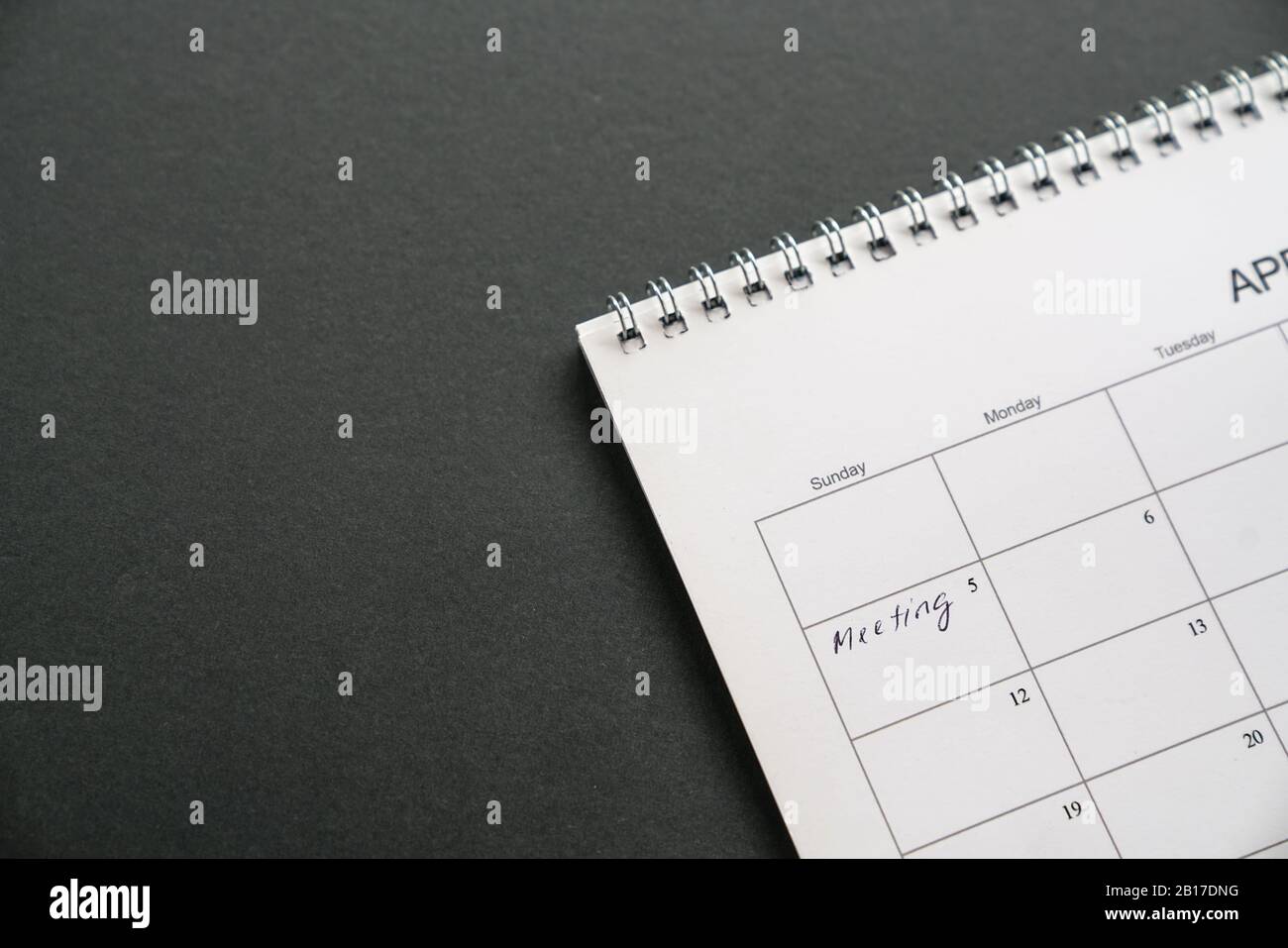 White clean calendar on black background with copy space. Words ...