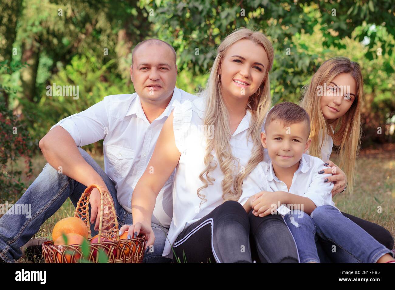 Happy family outside hugging and posing having picnic isolated outdoors ...
