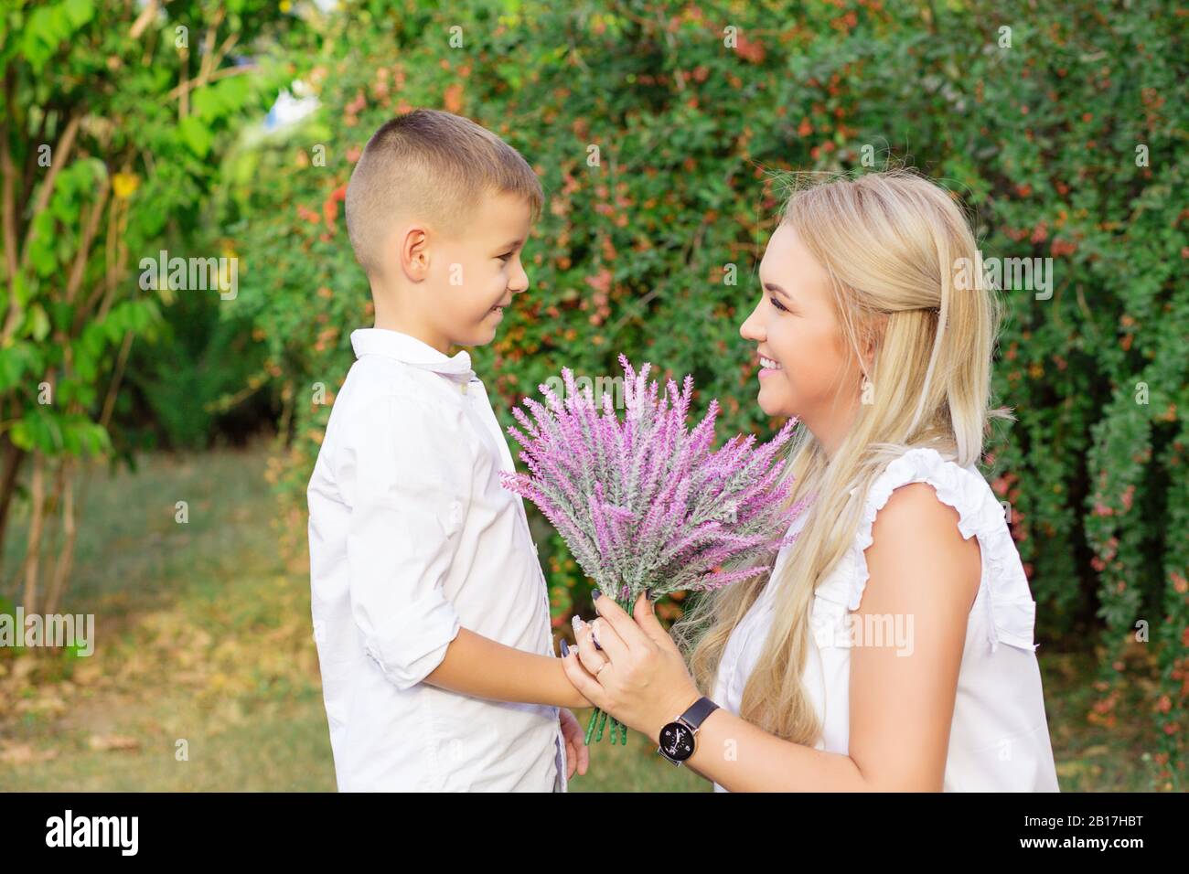 Son giving mother flowers hi-res stock photography and images - Alamy