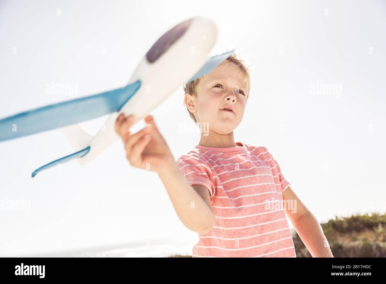 Boy playing with toy plane Stock Photo - Alamy