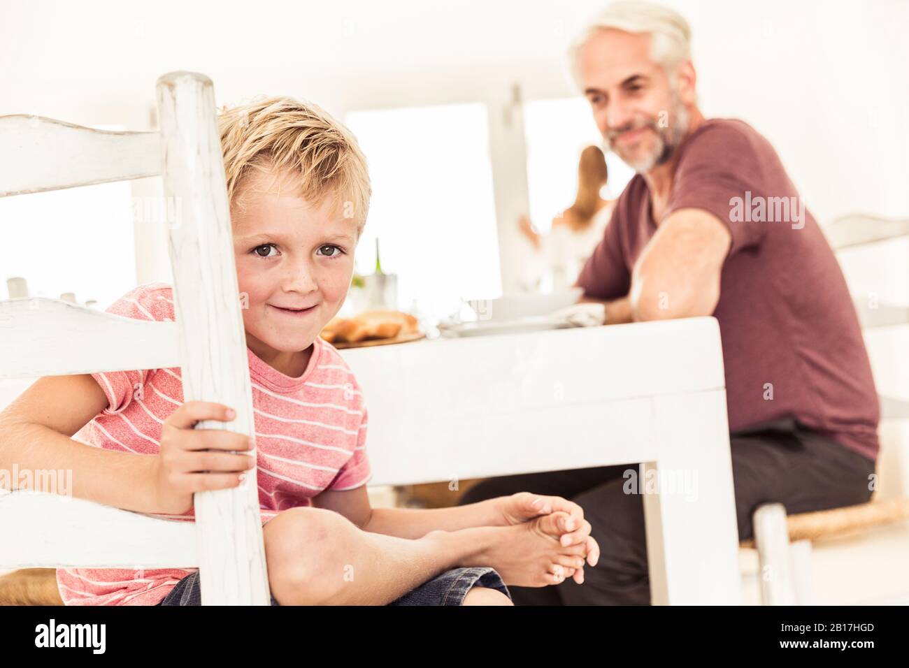 Portrait of smiling boy in dining room Stock Photo - Alamy