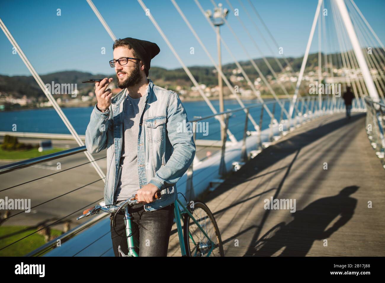 Using mobile phone riding a bike hi-res stock photography and images ...