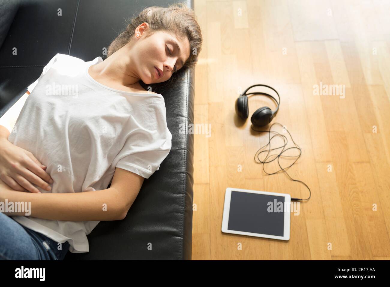 Woman napping on couch hi-res stock photography and images - Alamy