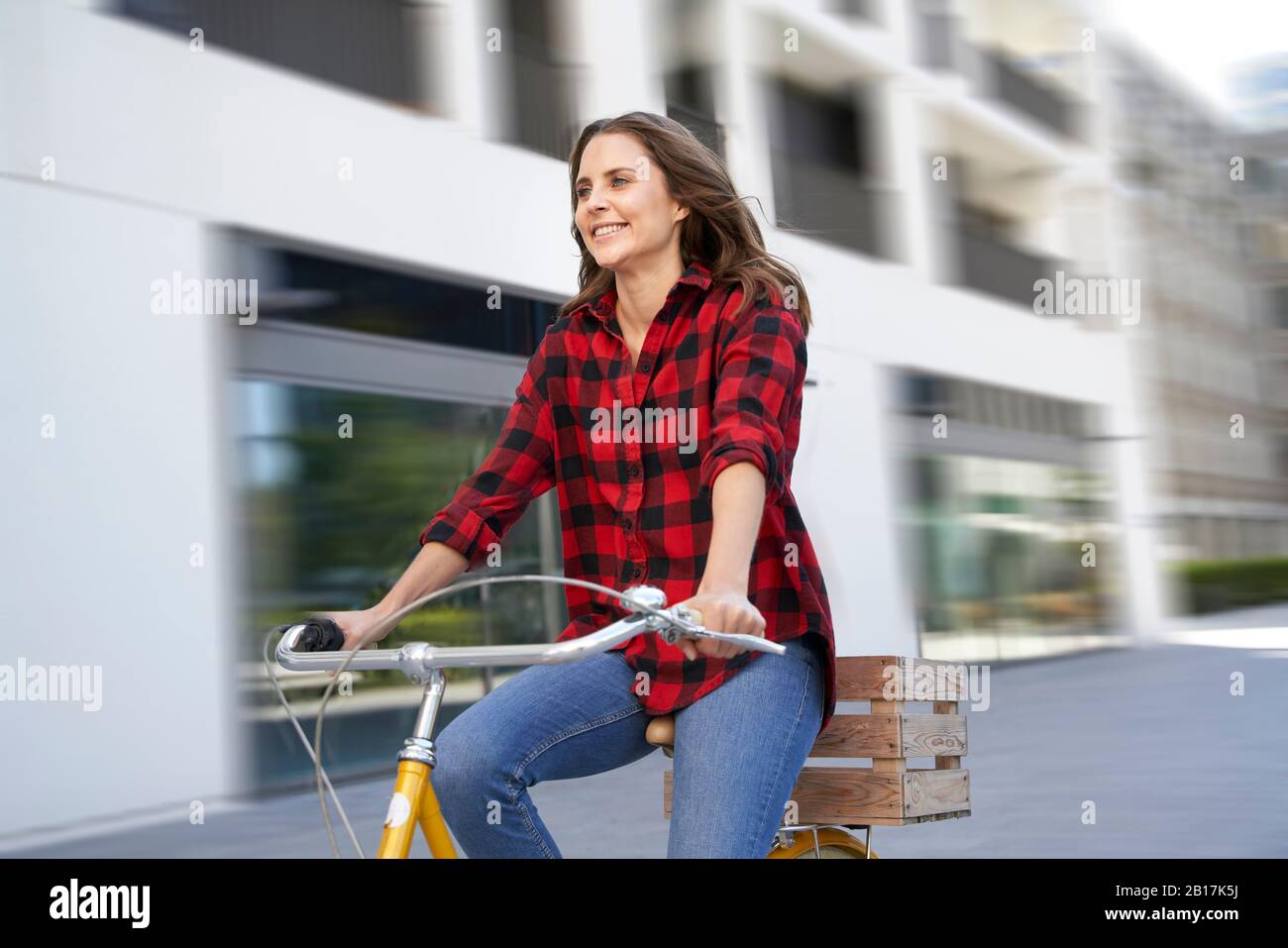 Attractive woman riding bicycle hi-res stock photography and images - Alamy