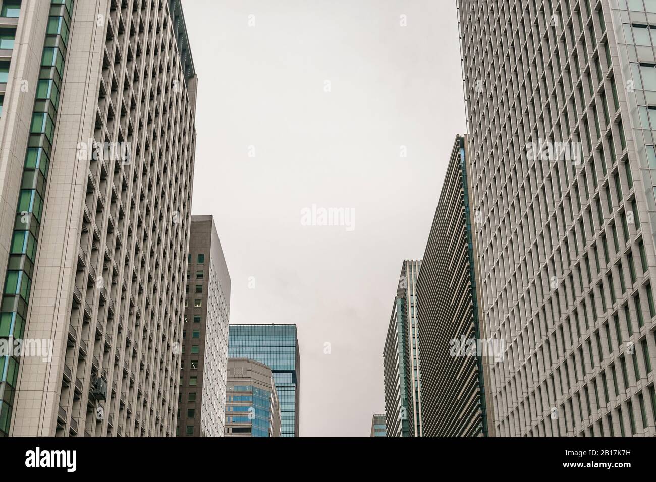 Low angle perspective view of modern tall buildings at chiyoda district ...