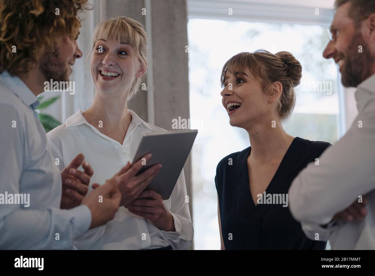 Happy business team having a meeting in office Stock Photo - Alamy