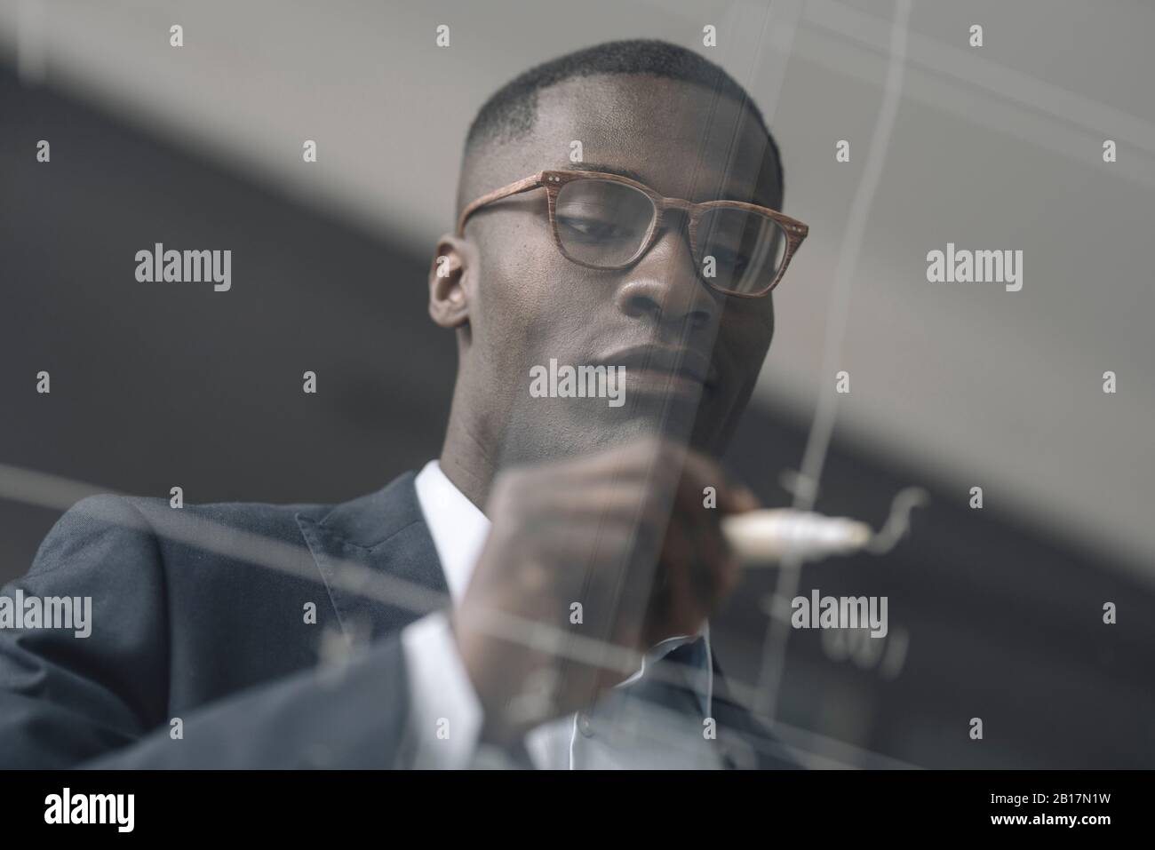 Drawing diagram on glass pane in office hi-res stock photography and ...