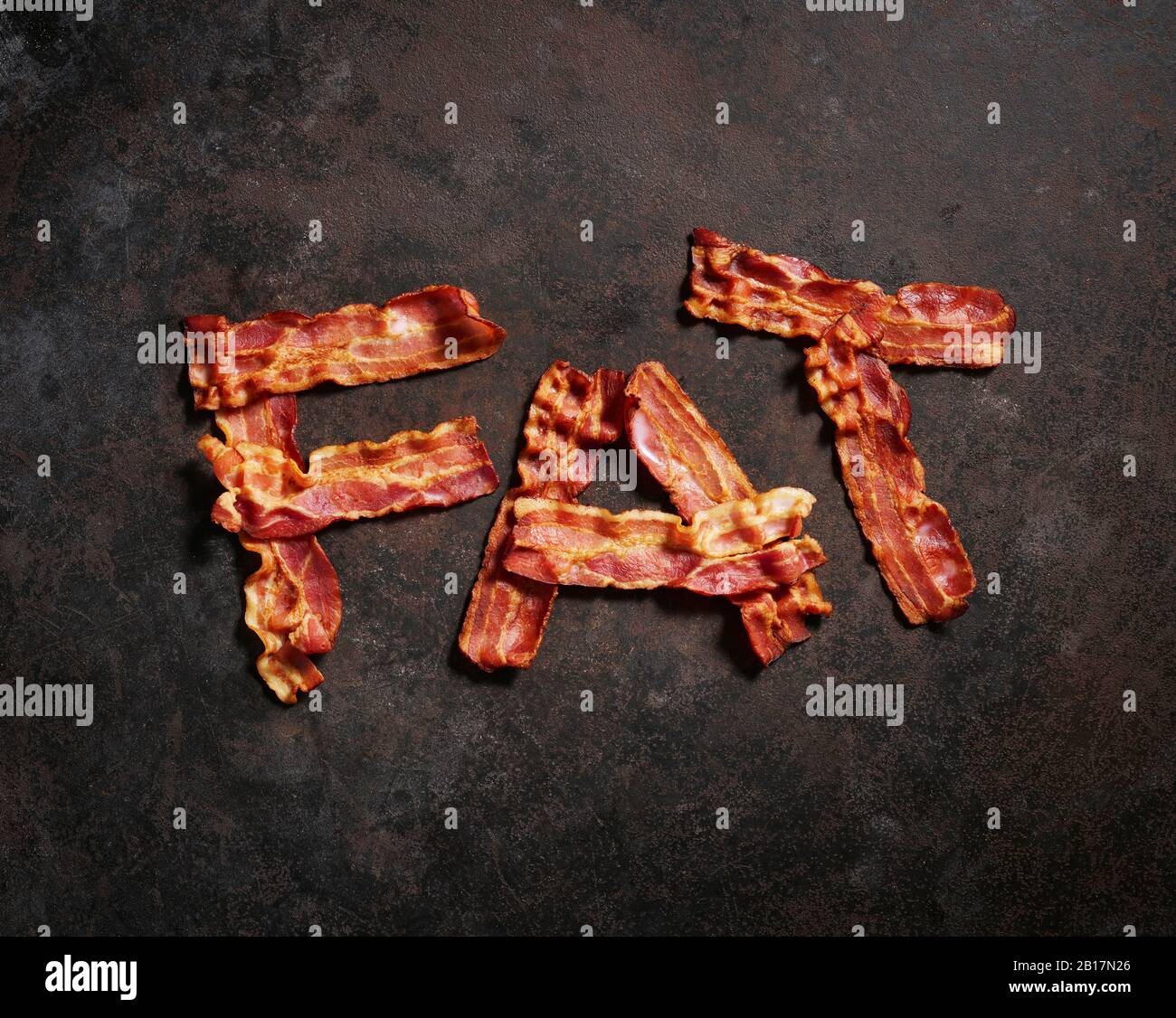 Bacon strips arranged in word FAT against metal surface Stock Photo - Alamy