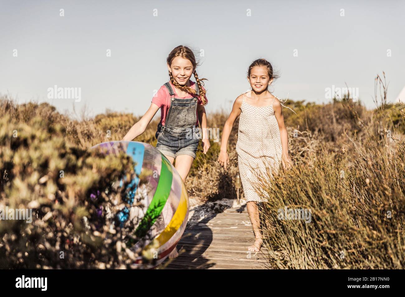 Two girls running on boardwalk hi-res stock photography and images - Alamy