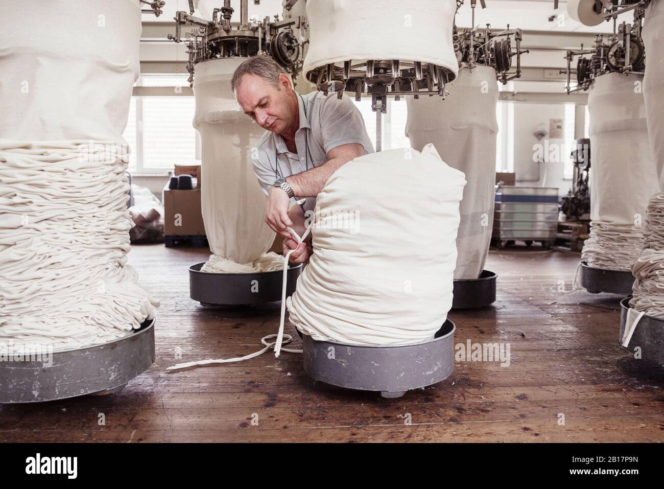 Man working in a textile factory Stock Photo - Alamy