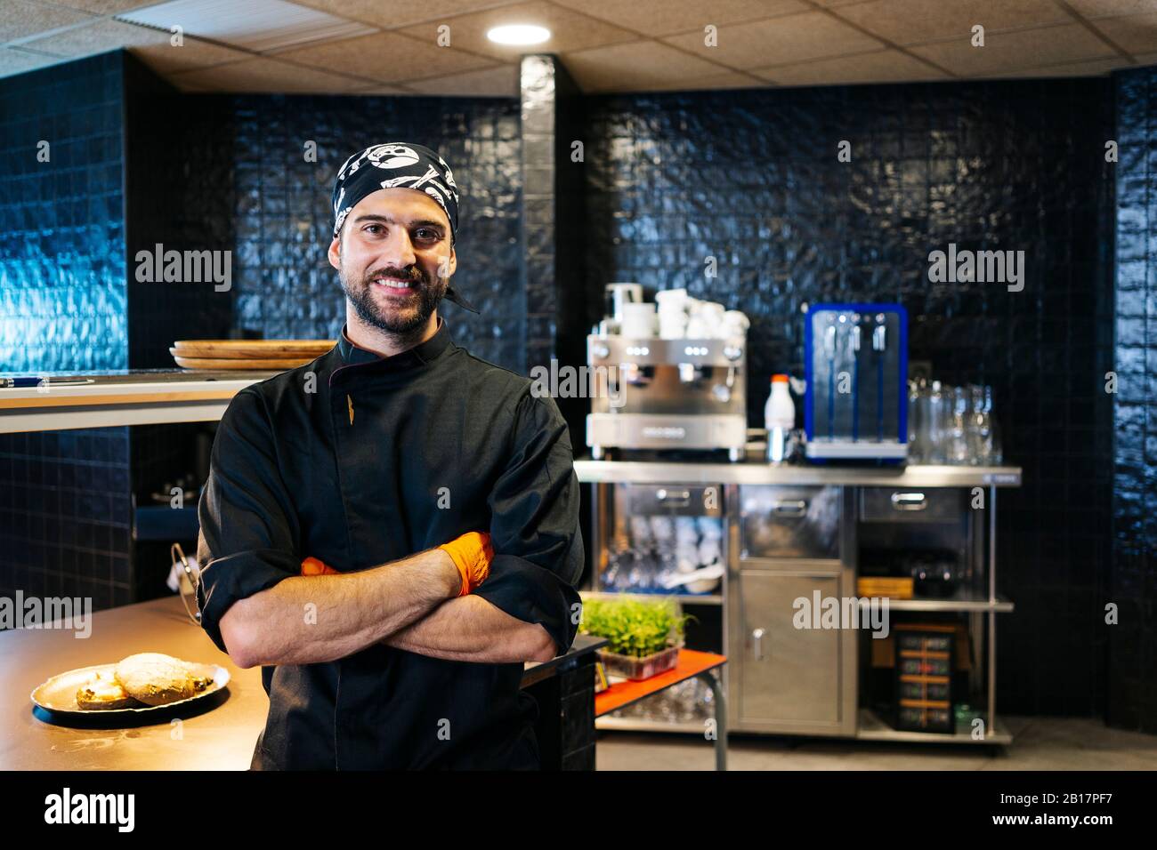 Portrait of smiling chef in restaurant kitchen Stock Photo - Alamy