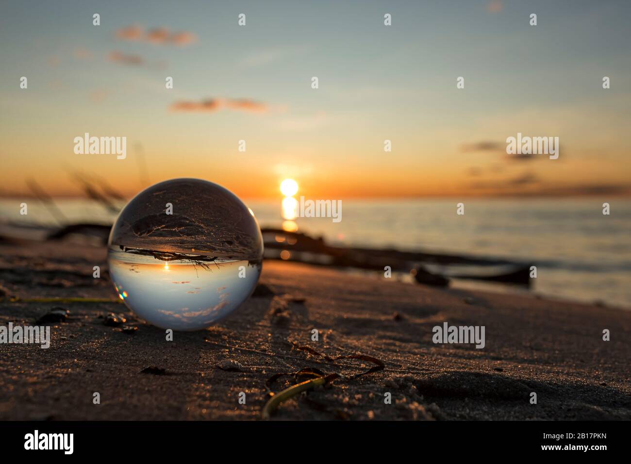Shiny glass ball lying sandy coastal beach sunset hi-res stock ...